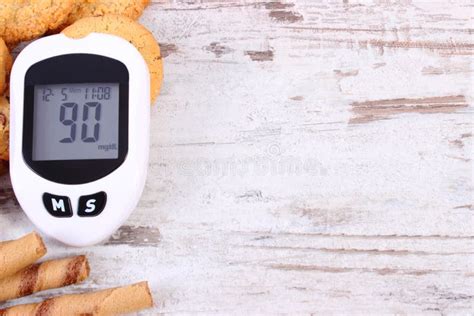 Glucose Meter For Checking Sugar Level And Cookies Diabetes Reduction Eating Sweets Concept