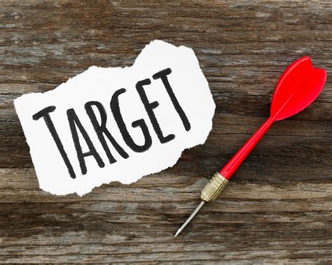 Free Photo Top View Of Target Written On Piece Of Paper And Dart