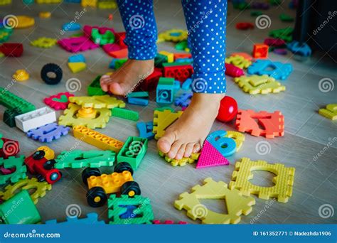Too Much Toys At Home Girl Steps On Toys Trying To Go Through Stock