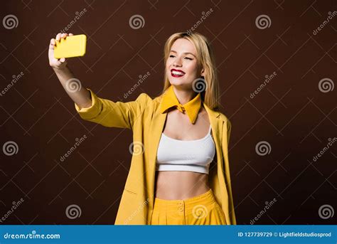 Beautiful Smiling Stylish Blonde Girl Taking Selfie With Yellow