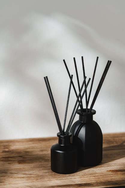 Premium Photo Minimalist Aromatic Reed Diffusers On A Wooden Surface