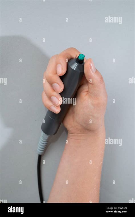 Close Up Image Showing A Hand Holding A Wired Dental Tool The Image
