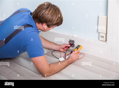 Electrician Checking Socket Voltage Stock Photo Alamy