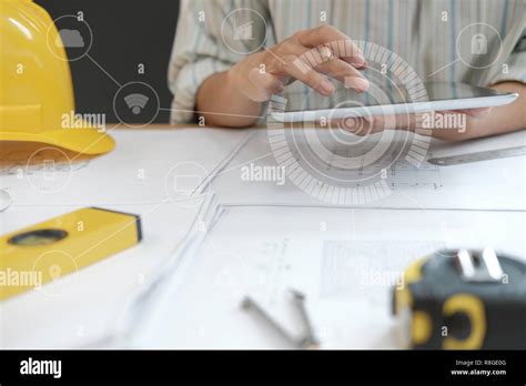 Architect Using Tablet Engineer Working On House Blueprint Of Real Estate Project At Workplace