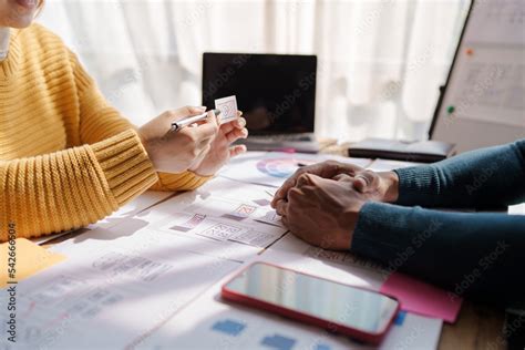 A UX Design Team Is A Confluence Of User Research UX UI Design With Layout Paper On Desk