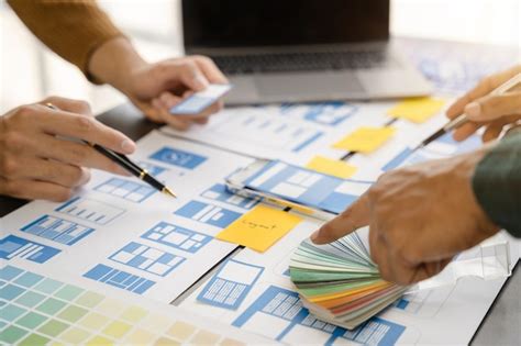 Premium Photo Ui Designer Brainstorming About Mobile App Interface Wireframe Design With