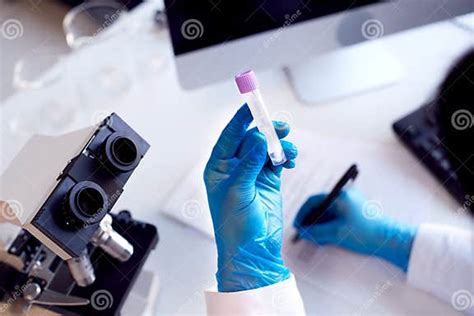 Close Up Of Lab Worker Conducting Research Using Microscope Holding