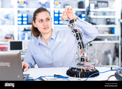 A Girl In A University Laboratory Is Experimenting With A Robot Stock Photo Alamy