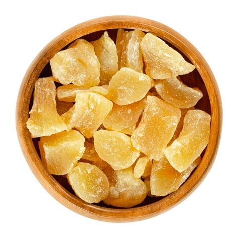 Premium Photo Candied Ginger Chunks In Wooden Bowl Over White