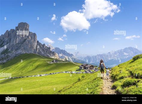 Mother And Son Walking On A Path At Giau Pass Enjoying The Beautiful