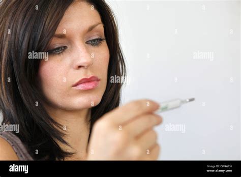 Woman Measuring Her Temperature Stock Photo Alamy