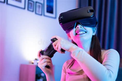 asian modern female gamer having serious fun playing games from vr