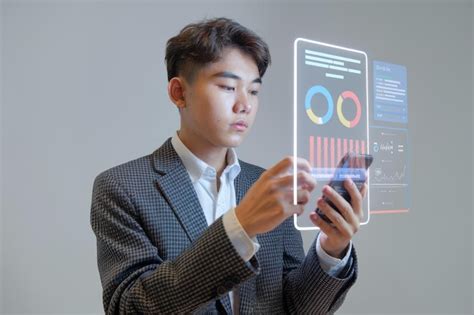 Young Asian Businessman Analyzing Data Digital Tablet Graphs Modern