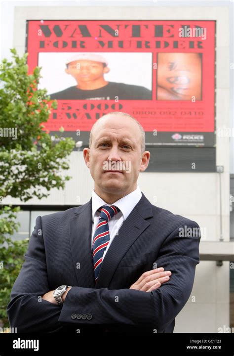Detective Superintendent Paul Rumney With The Wanted Poster Being