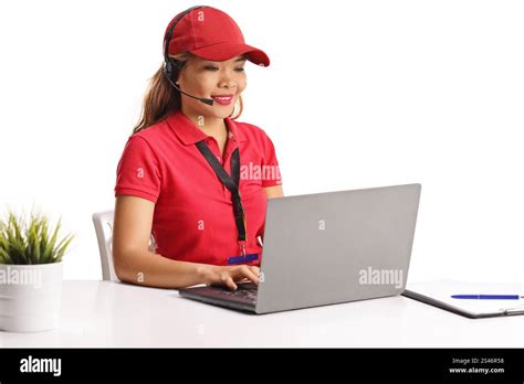 Asian Female Worker In A Dispatch Center Working With A Laptop Computer Isolated On White